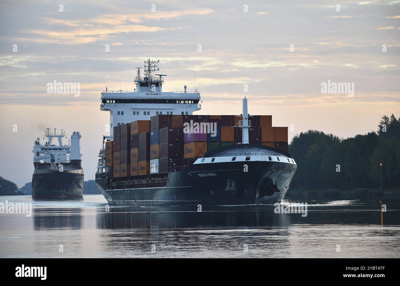 Container ship Nordic Porto sailing at sunrise in the Kiel Canal, Kiel ...