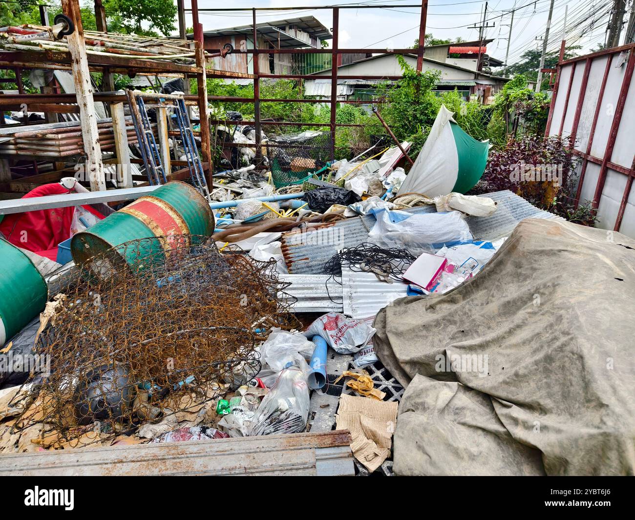 A pile of garbage with a bucket, rope, bottles, and other items at a ...