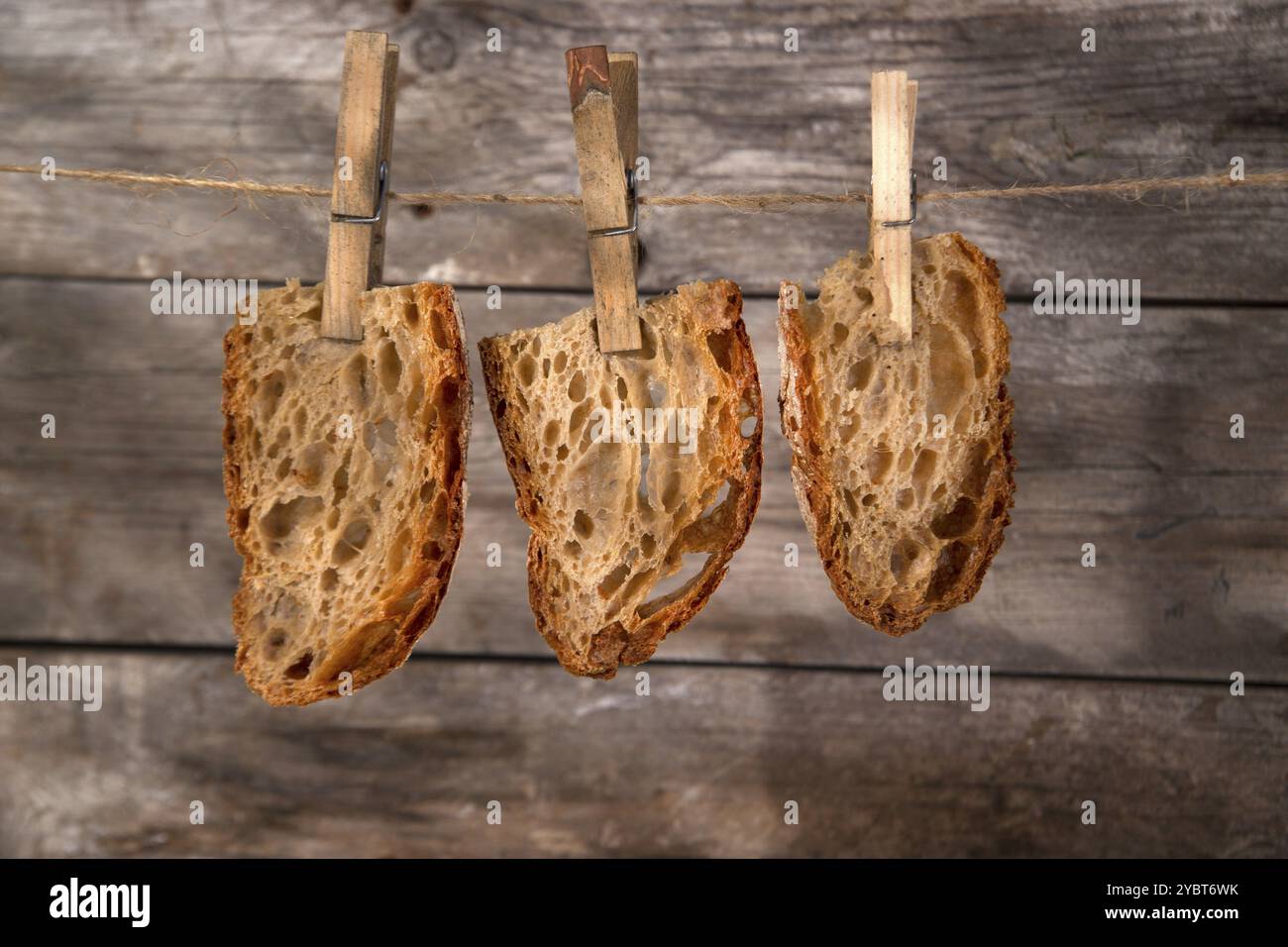 Slice of whole wheat bread sourdough baked in a wood oven hanging Stock ...