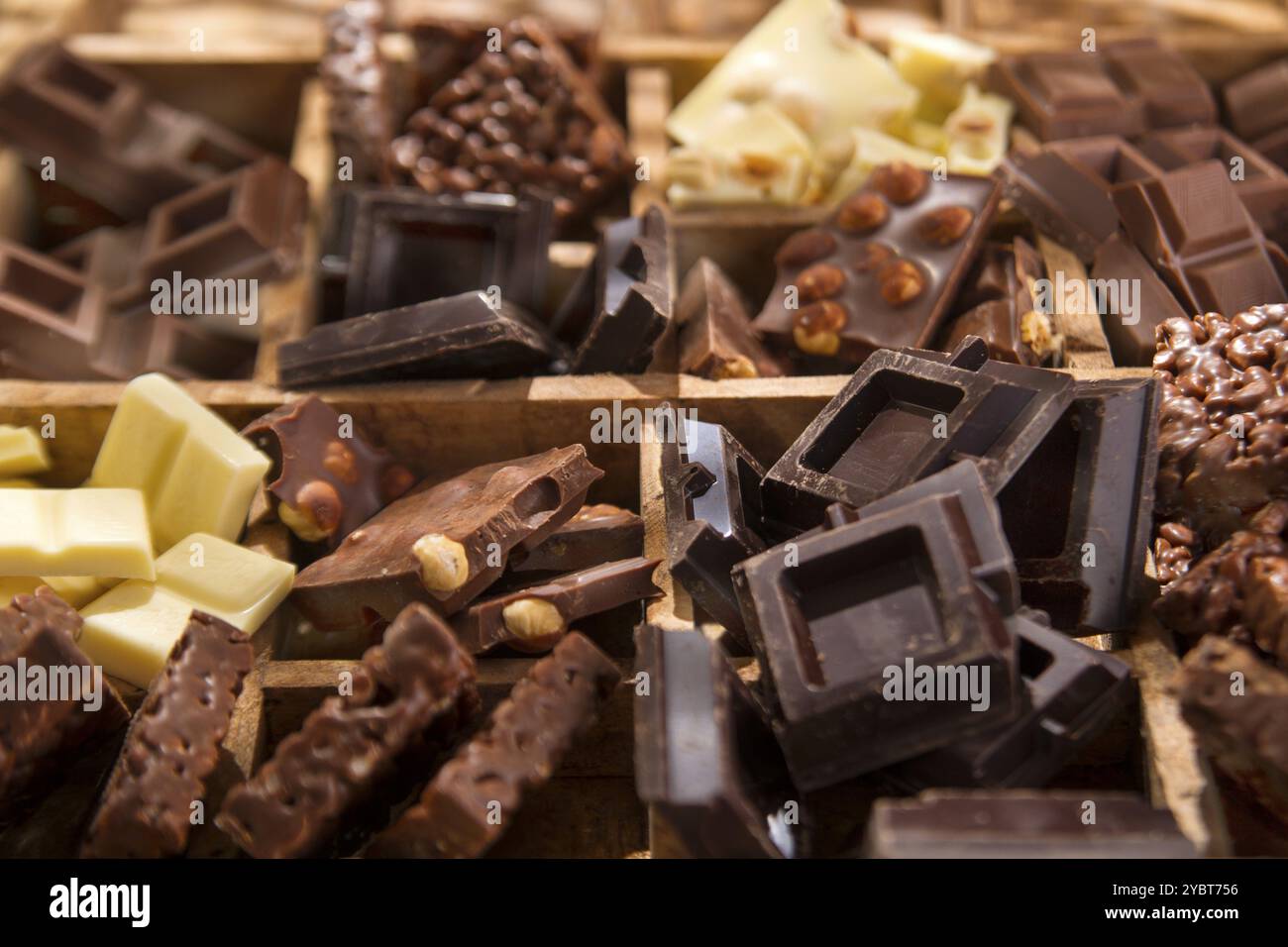 Little cubes of chocolate in various colors in wooden box Stock Photo ...