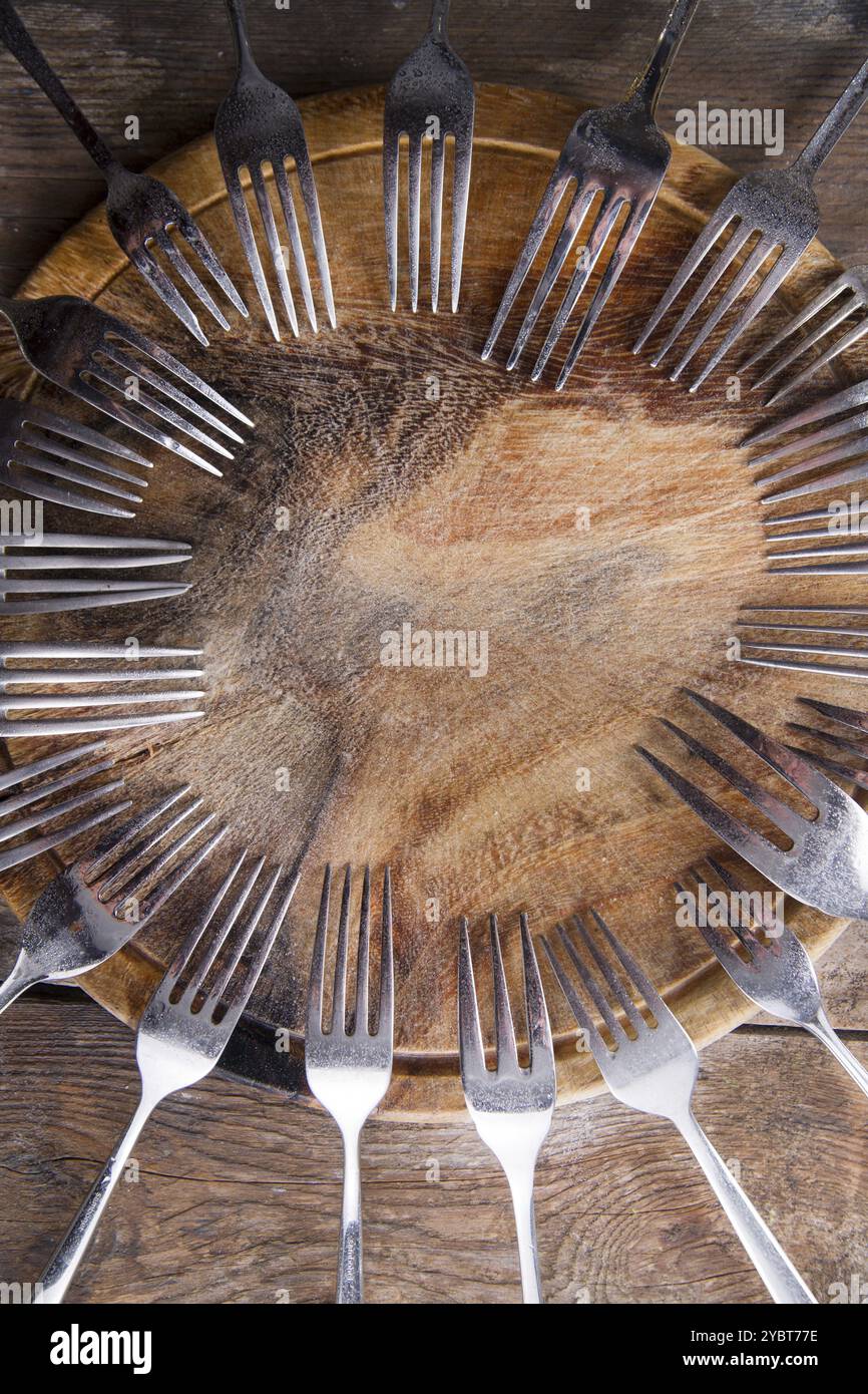 Sets of forks different shapes arranged on chopping round Stock Photo ...