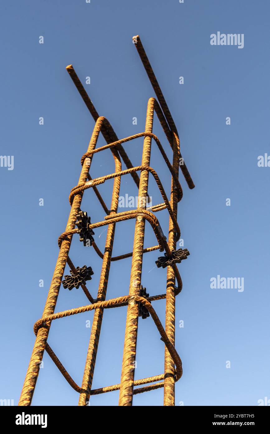 Pillar rebars against sky. Construction site with steel reinforcing ...