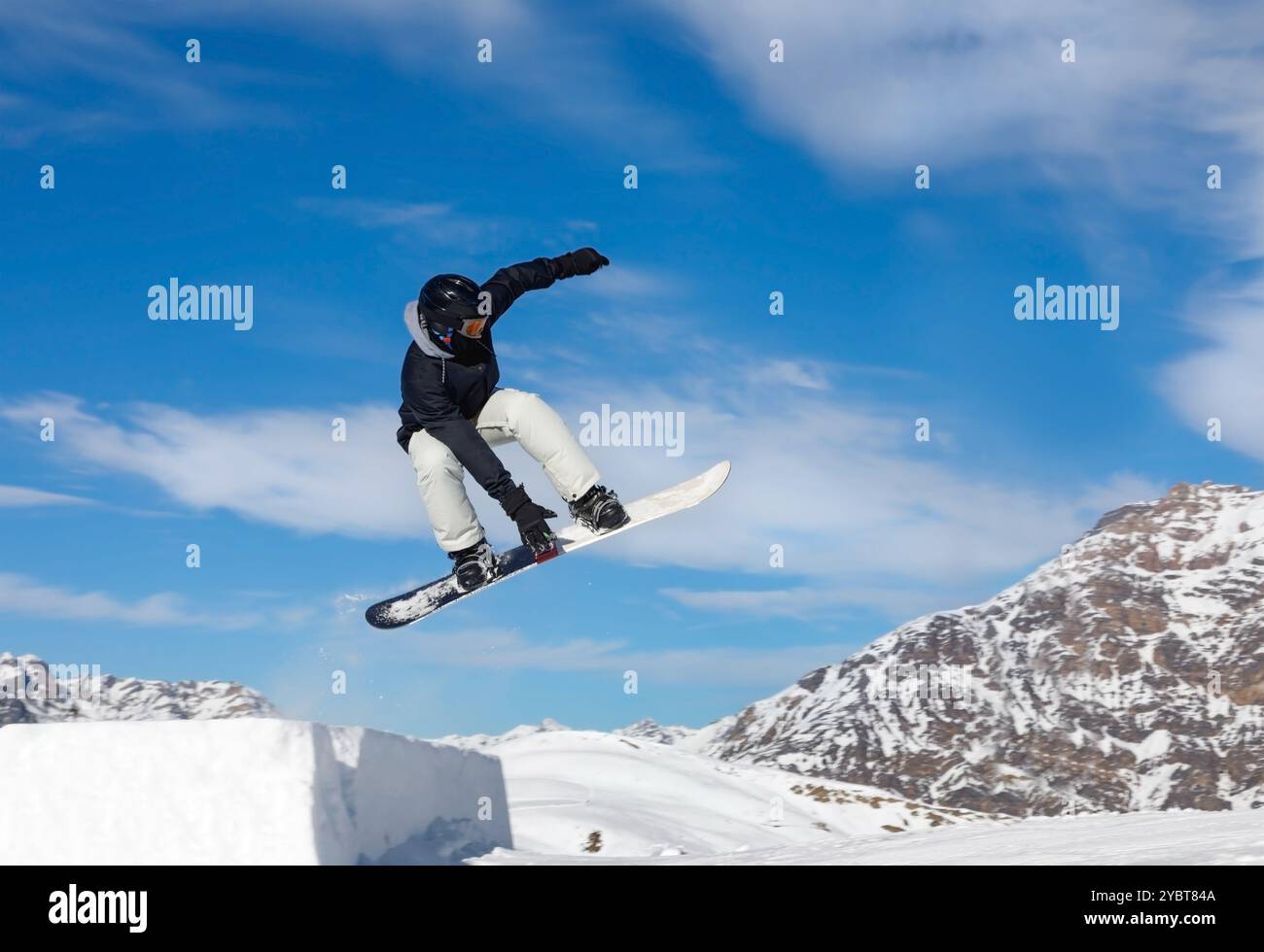 Snowboarder jumps in air with blue sky background Stock Photo - Alamy