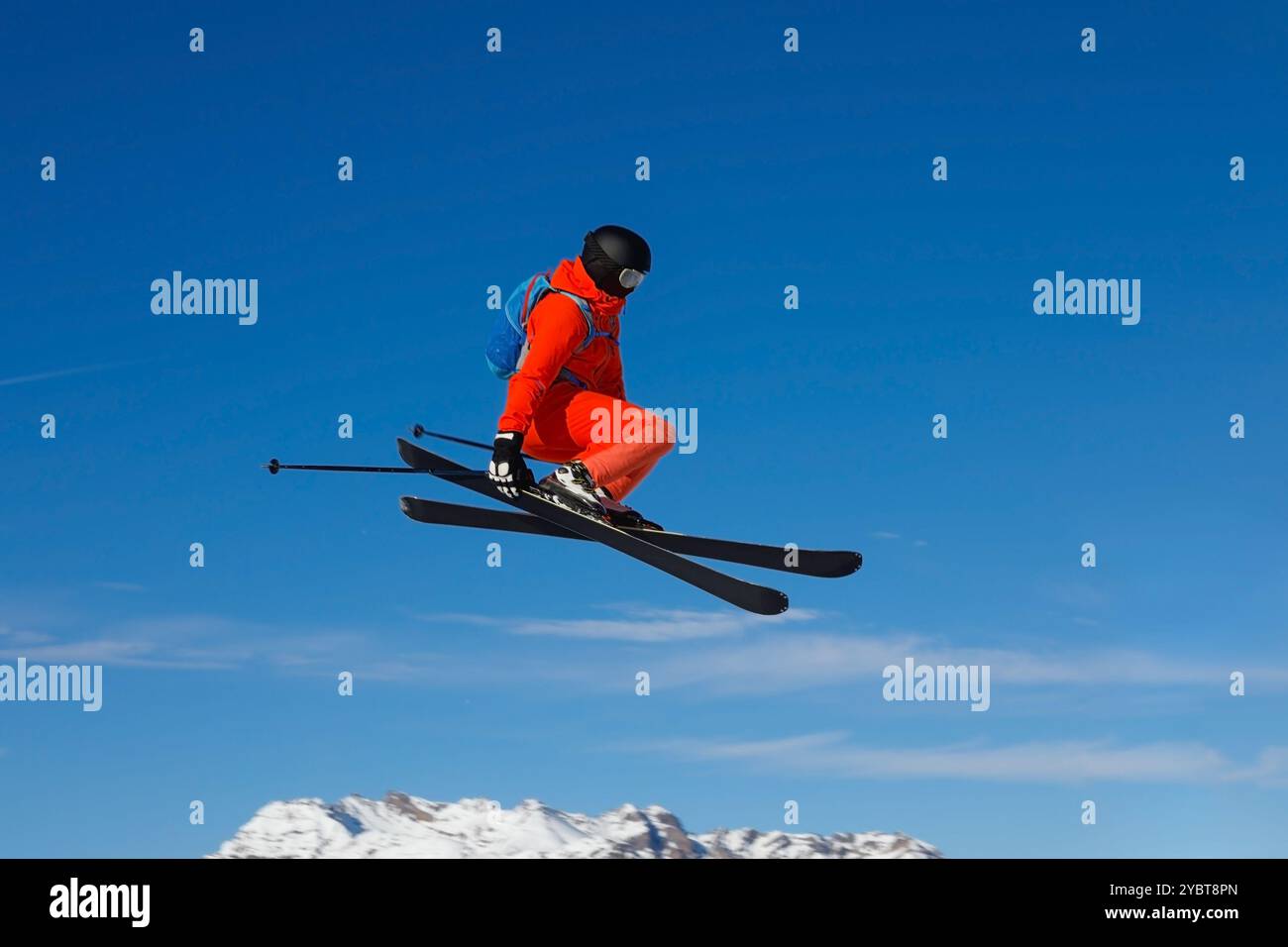 Male skier jumps high in air with blue sky background. Livigno, Italy ...