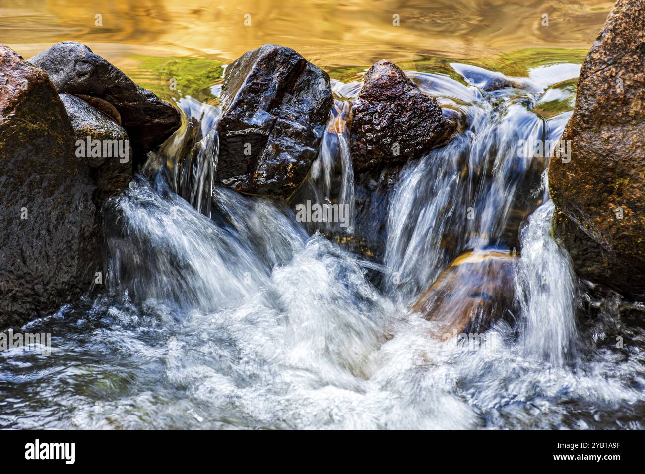 Water flowing between rocks in a small stream Stock Photo - Alamy