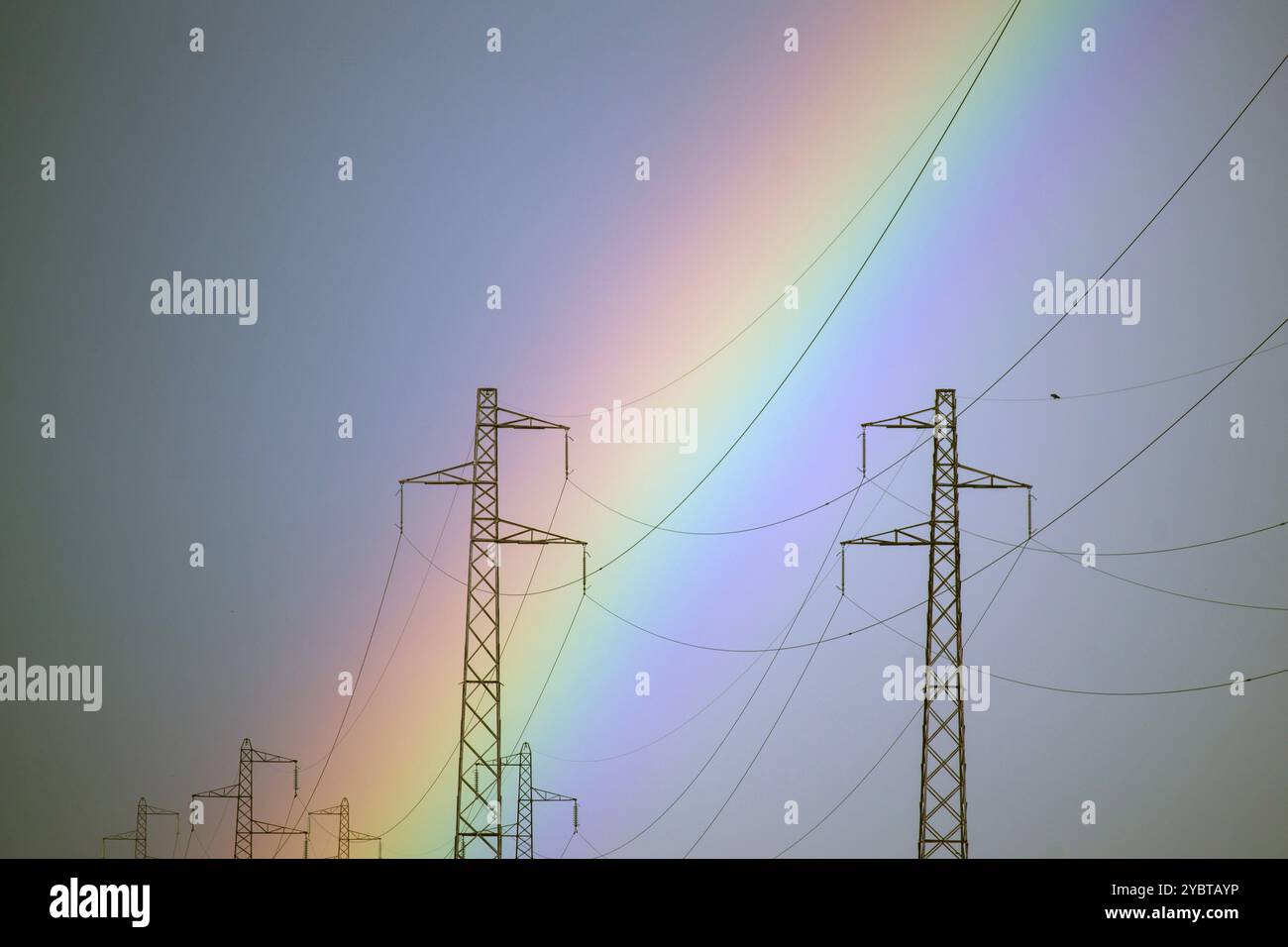 Effects arc of a rainbow near a high-voltage power line Stock Photo - Alamy
