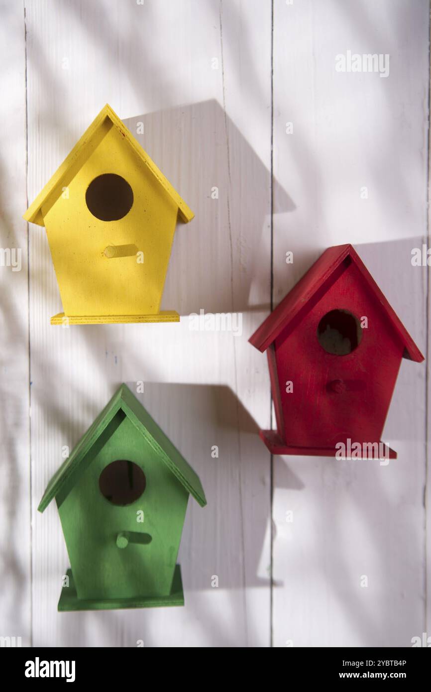 Small colorful houses for shelter birds hung on a wall Stock Photo - Alamy