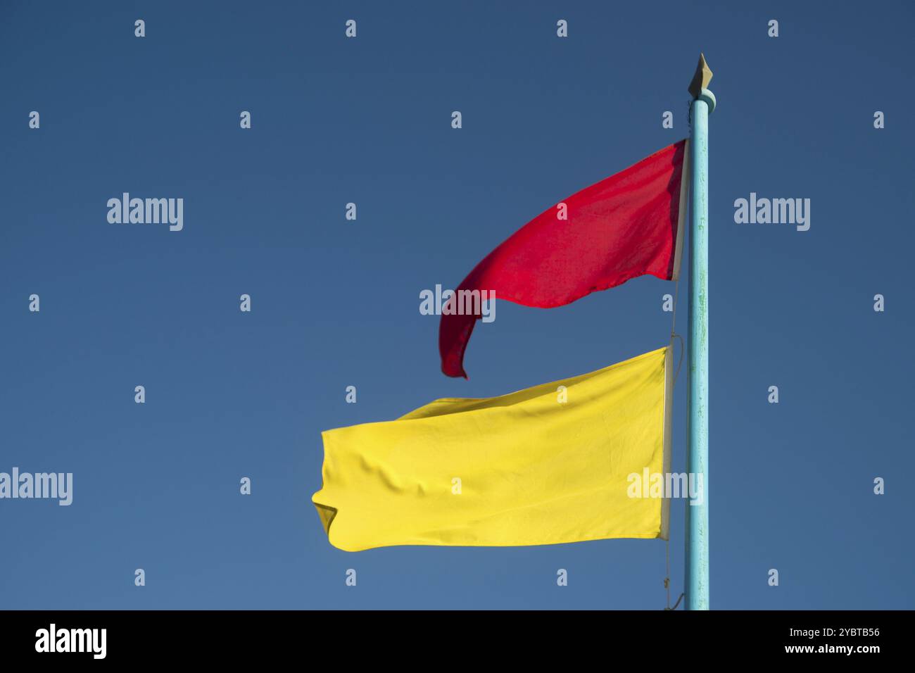 Yellow and red flags of danger without the supervised beach Stock Photo ...