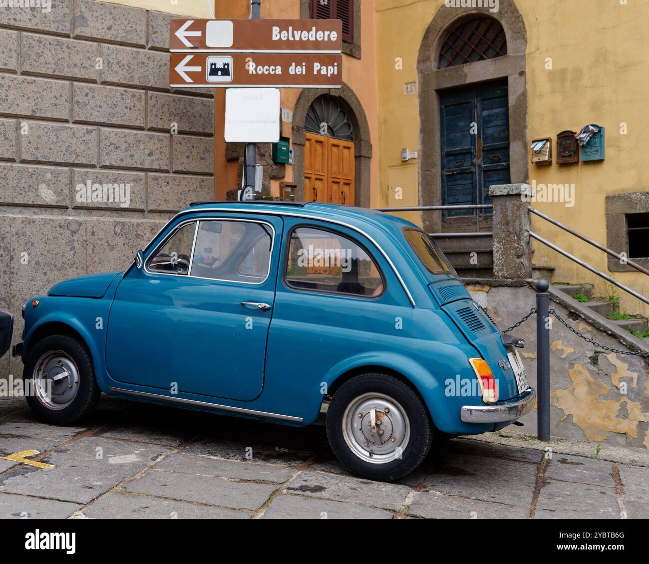Classic Fiat 500 car in the corner of a piazza in the town of ...