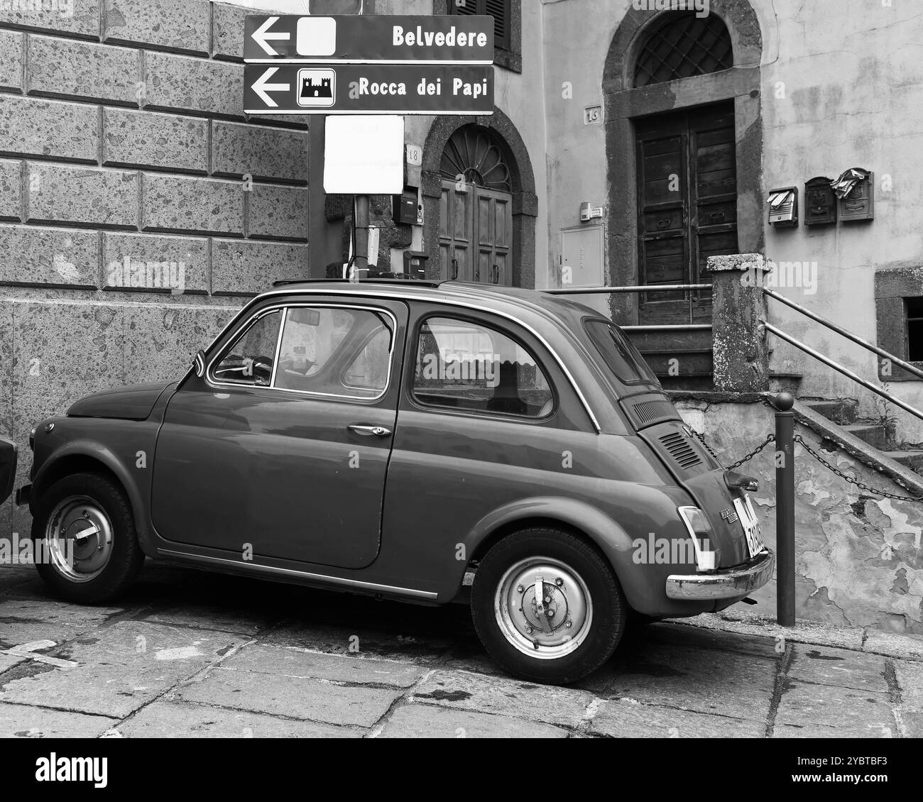 Classic Fiat 500 car in the corner of a piazza in the town of ...