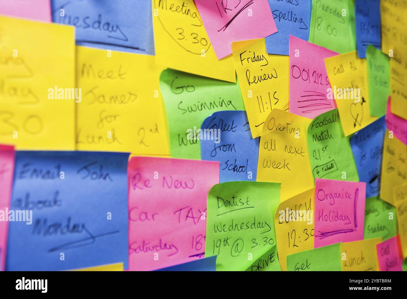 An assortment of post it notes with hand witten reminders on Stock ...