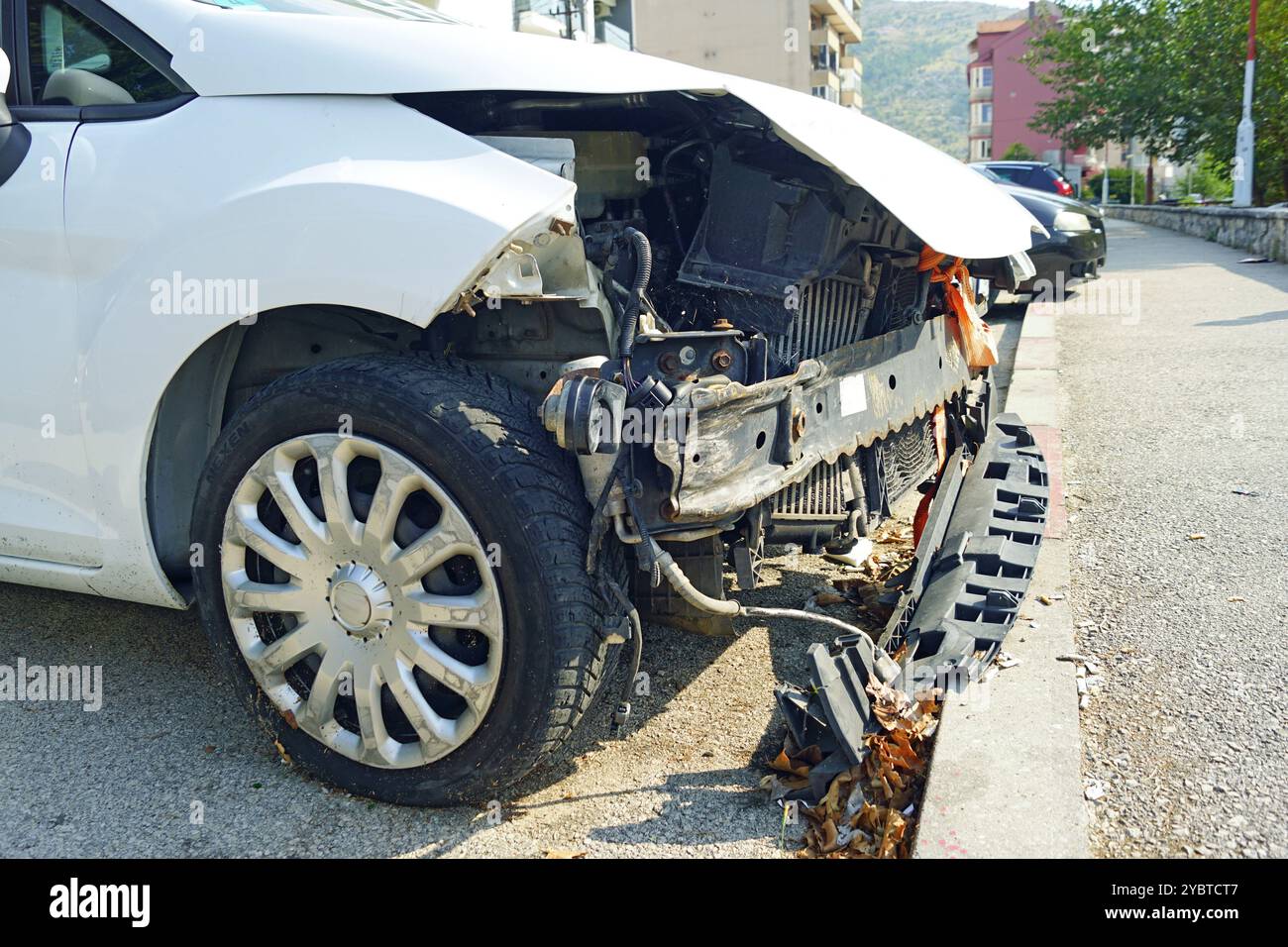 Consequences of drunk driving: a car with a fallen off bumper, a broken ...