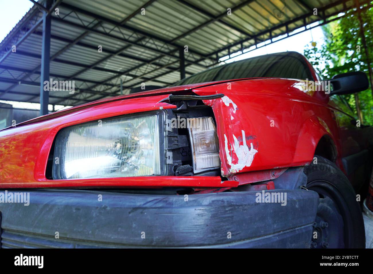 A close-up photo of the front of a car with damage after a collision ...