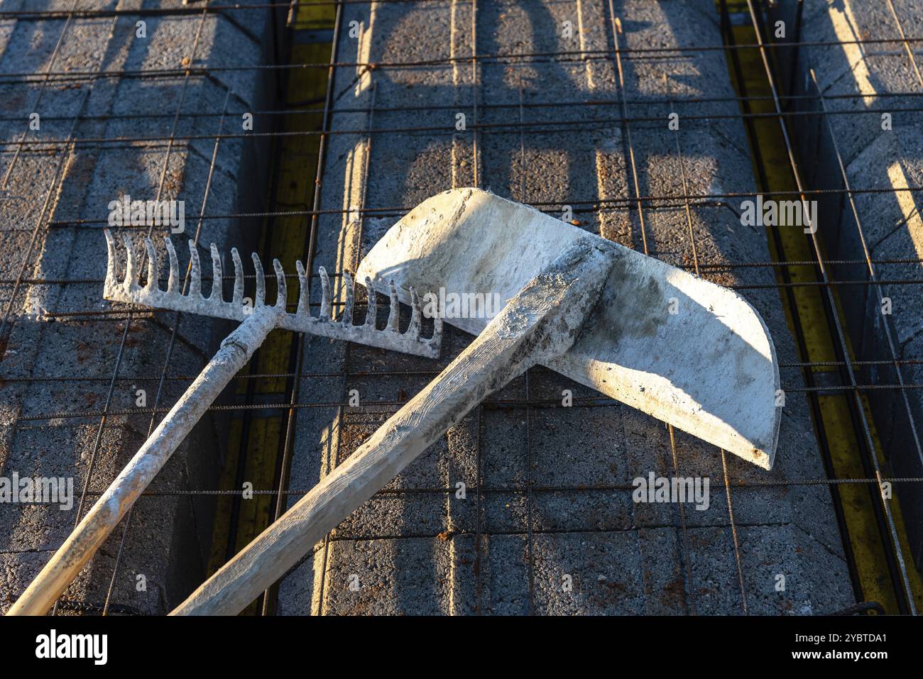 Construction equipment, shovel and rake for pouring concrete into a ...