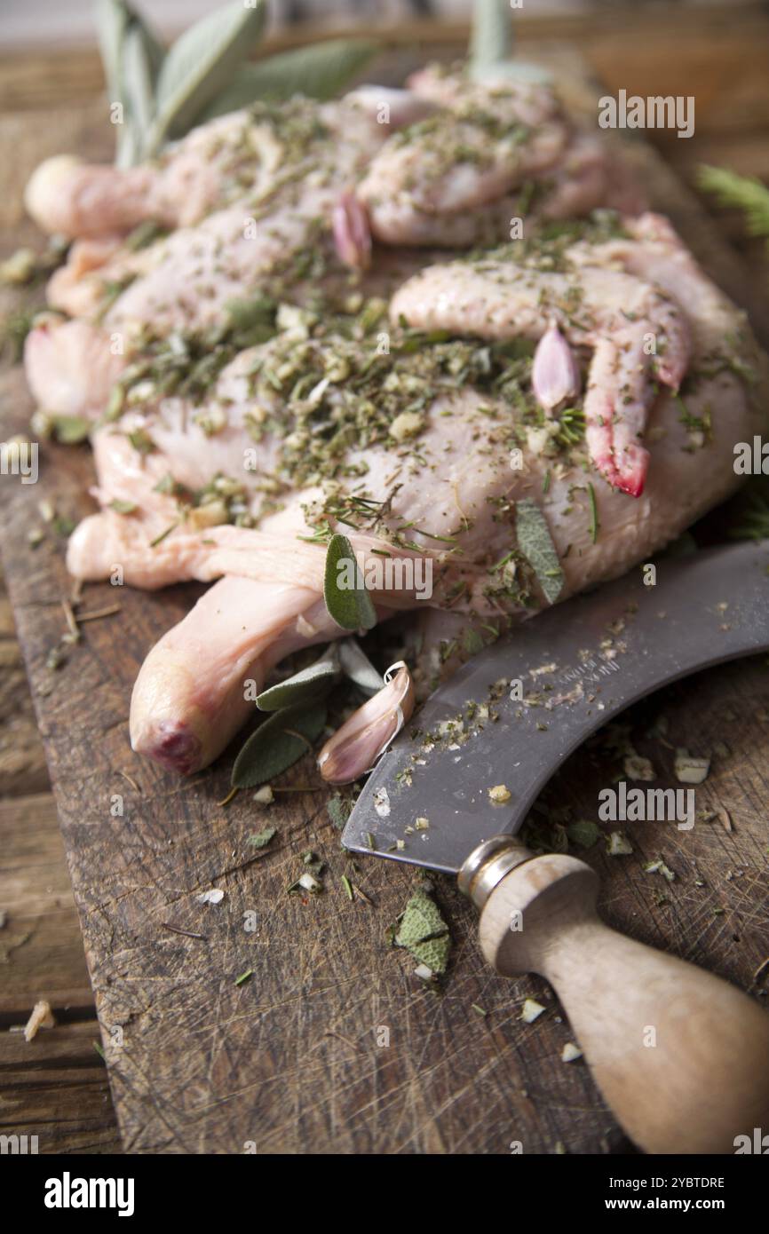 Preparation of a whole chicken with Mediterranean herbs Stock Photo - Alamy