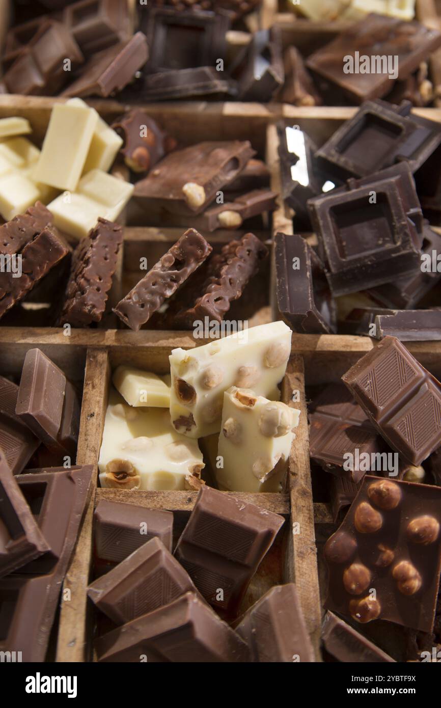 Little cubes of chocolate in various colors in wooden box Stock Photo ...