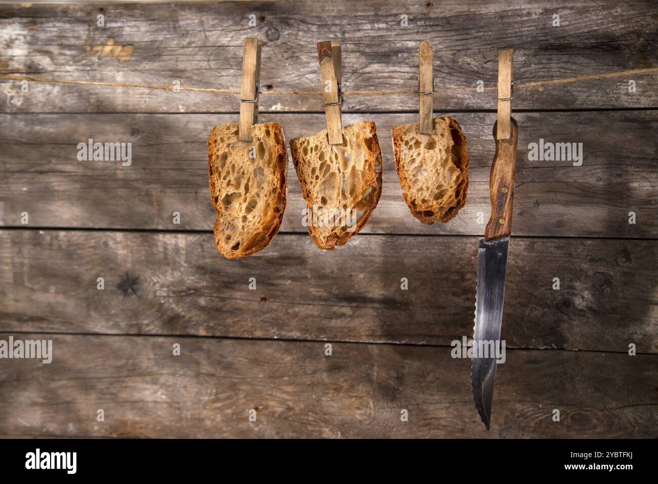 Slice of whole wheat bread sourdough baked in a wood oven hanging Stock ...