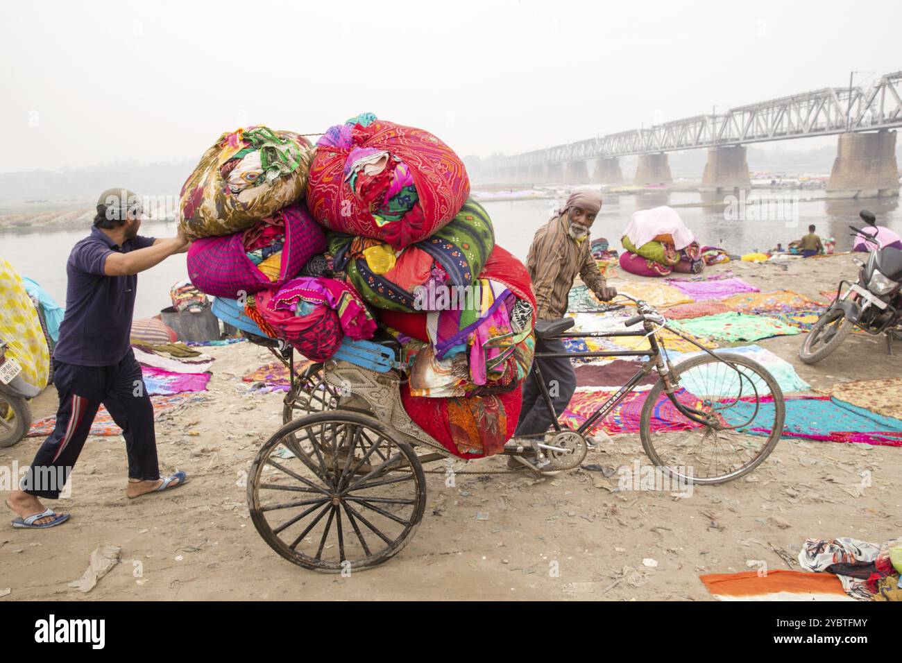 Old man deliver washed laundry on bicycle, Agra. India Stock Photo - Alamy