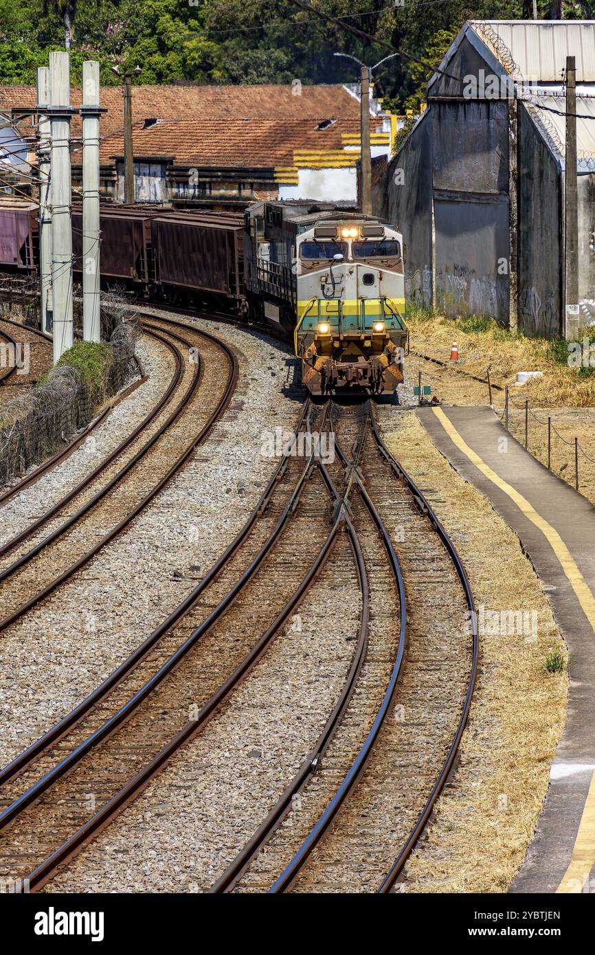 Train loaded with iron ore crossing the city in Minas Gerais, Brazil ...