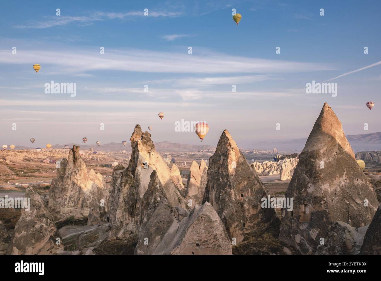 Rock formations with hot air balloons in the sky, wide landscape ...