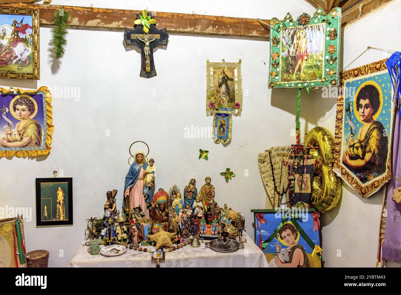 Altar with several images of saints, entities from religions of African ...