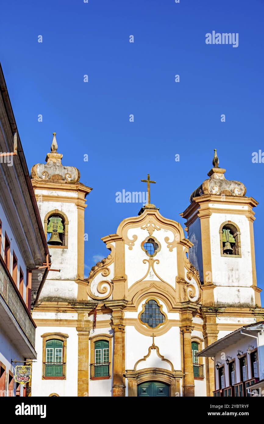 Front of historic baroque style church and surrounding colonial houses ...