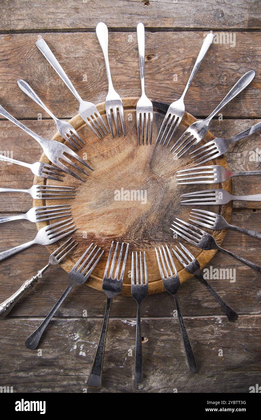 Sets of forks different shapes arranged on chopping round Stock Photo ...