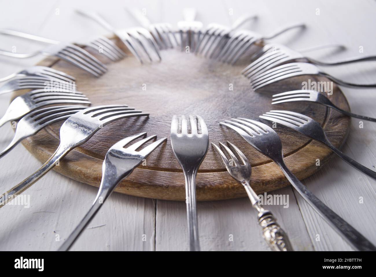 Sets of forks different shapes arranged on chopping round Stock Photo ...