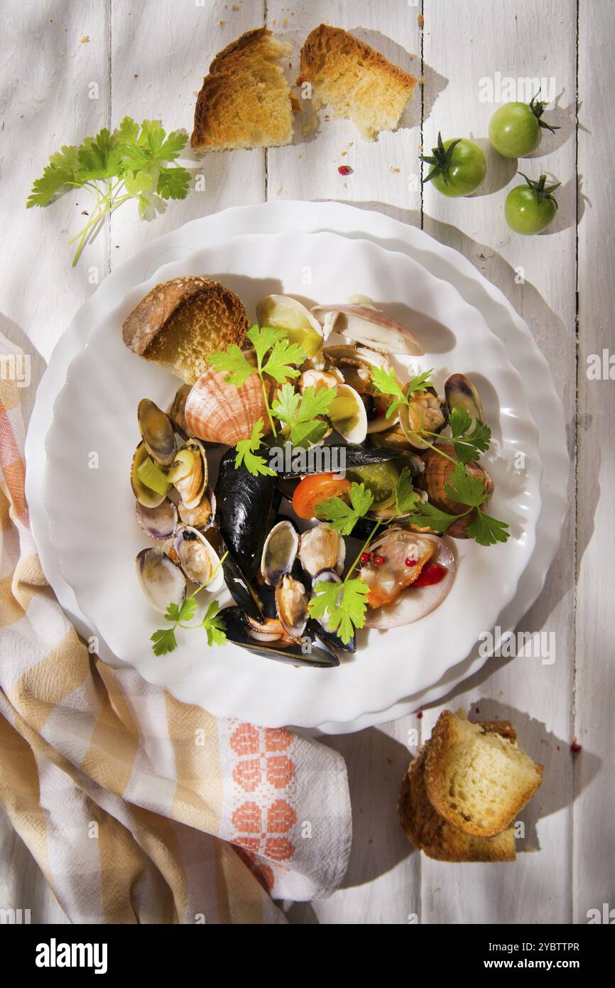 Presentation of a soup with seafood with roasted bread Stock Photo - Alamy