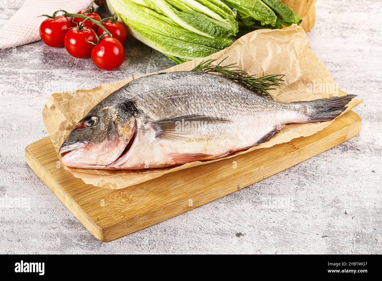 Raw dorada fish served rosemary for cooking Stock Photo - Alamy