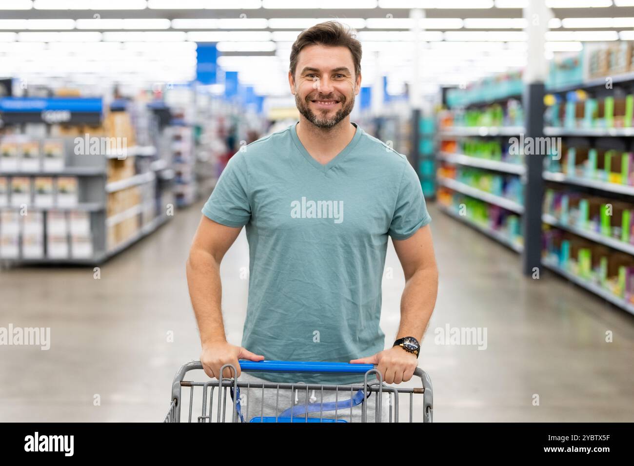 Happy Man shopper with shopping cart. Good purchases. Man purchases in ...