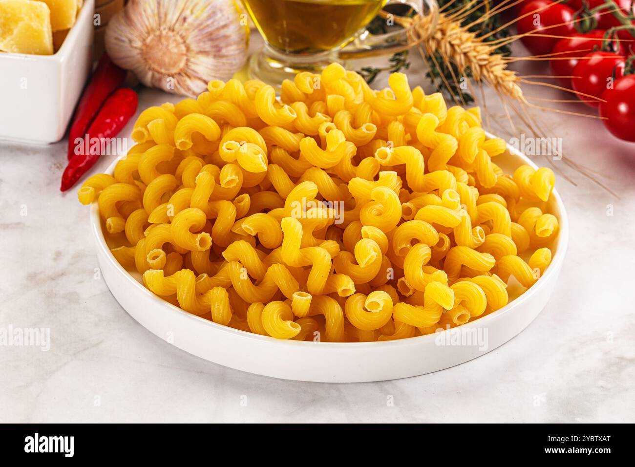 Italian cuisine - dry cellentani pasta for cooking Stock Photo - Alamy