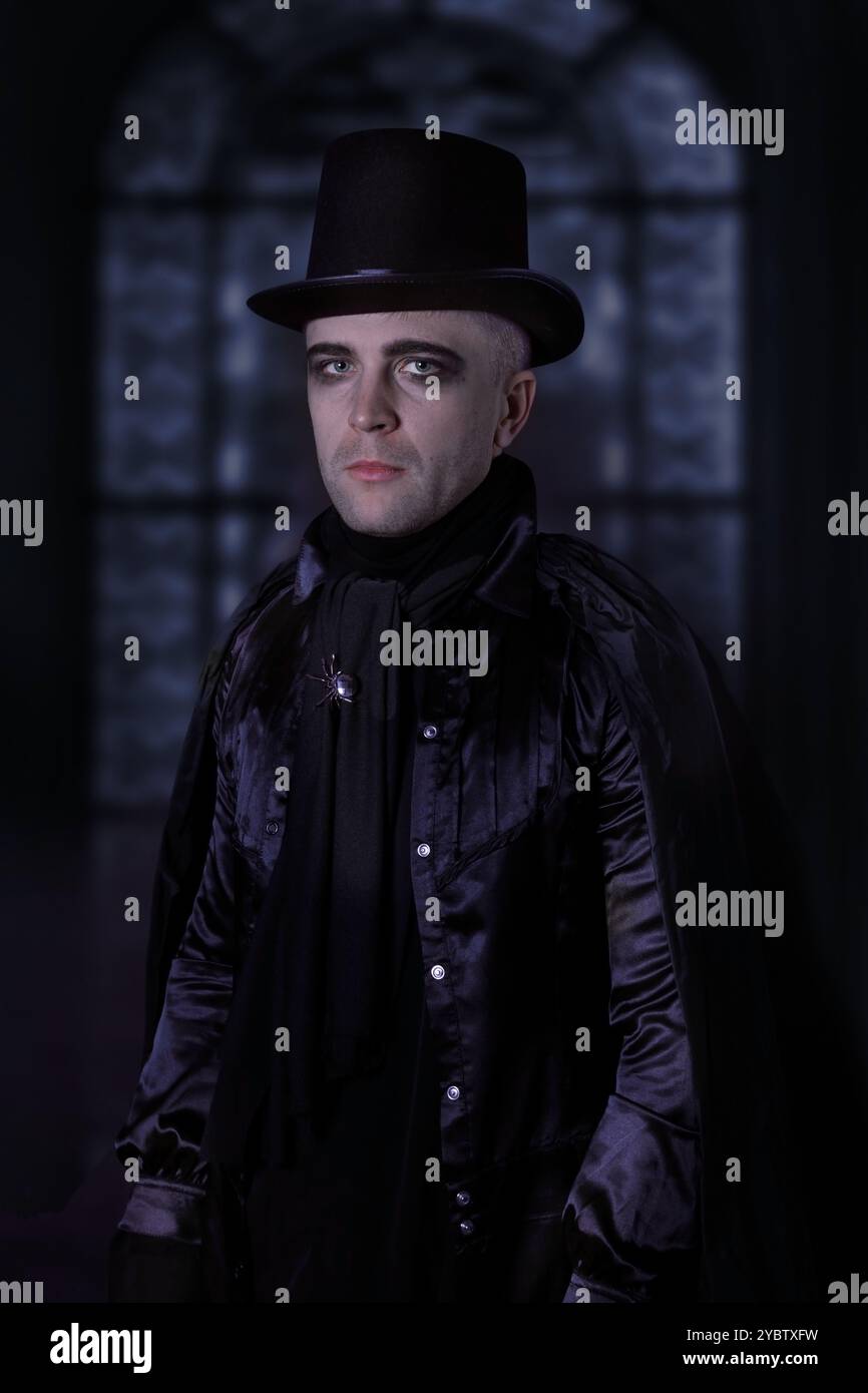 Portrait of a young handsome Lord of vampires in the darkness of an ...