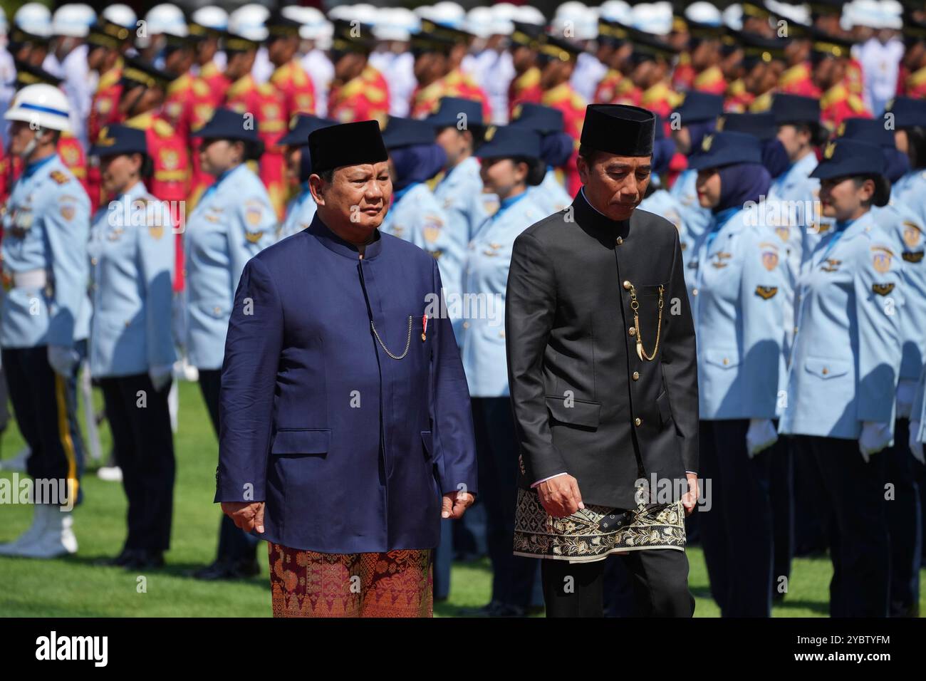 Indonesia's newly-inaugurated President Prabowo Subianto, left, walks ...