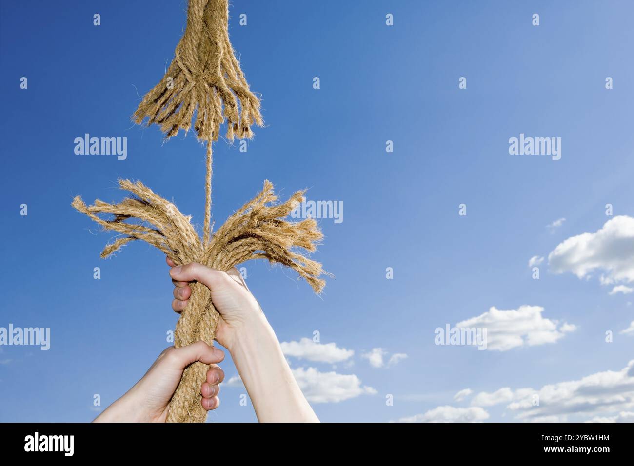 Man holding onto rope hi-res stock photography and images - Alamy
