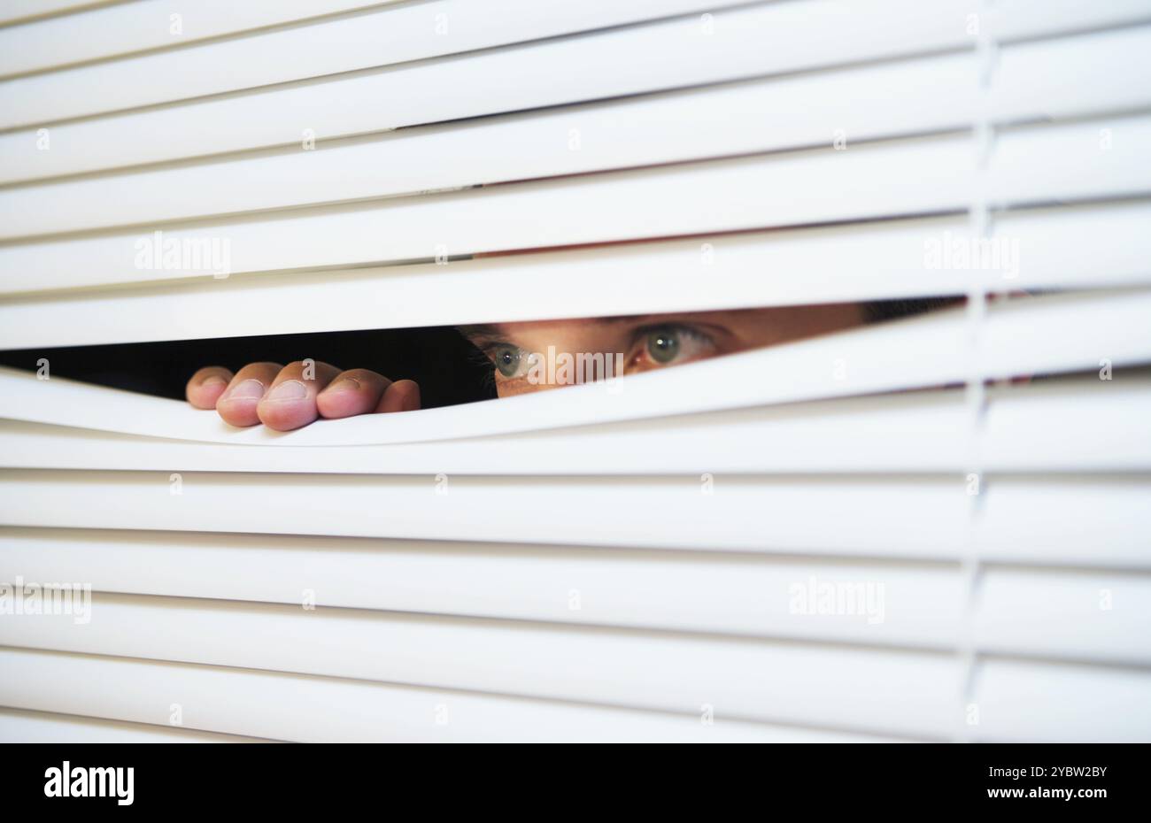 Man looks through blinds hi-res stock photography and images - Alamy
