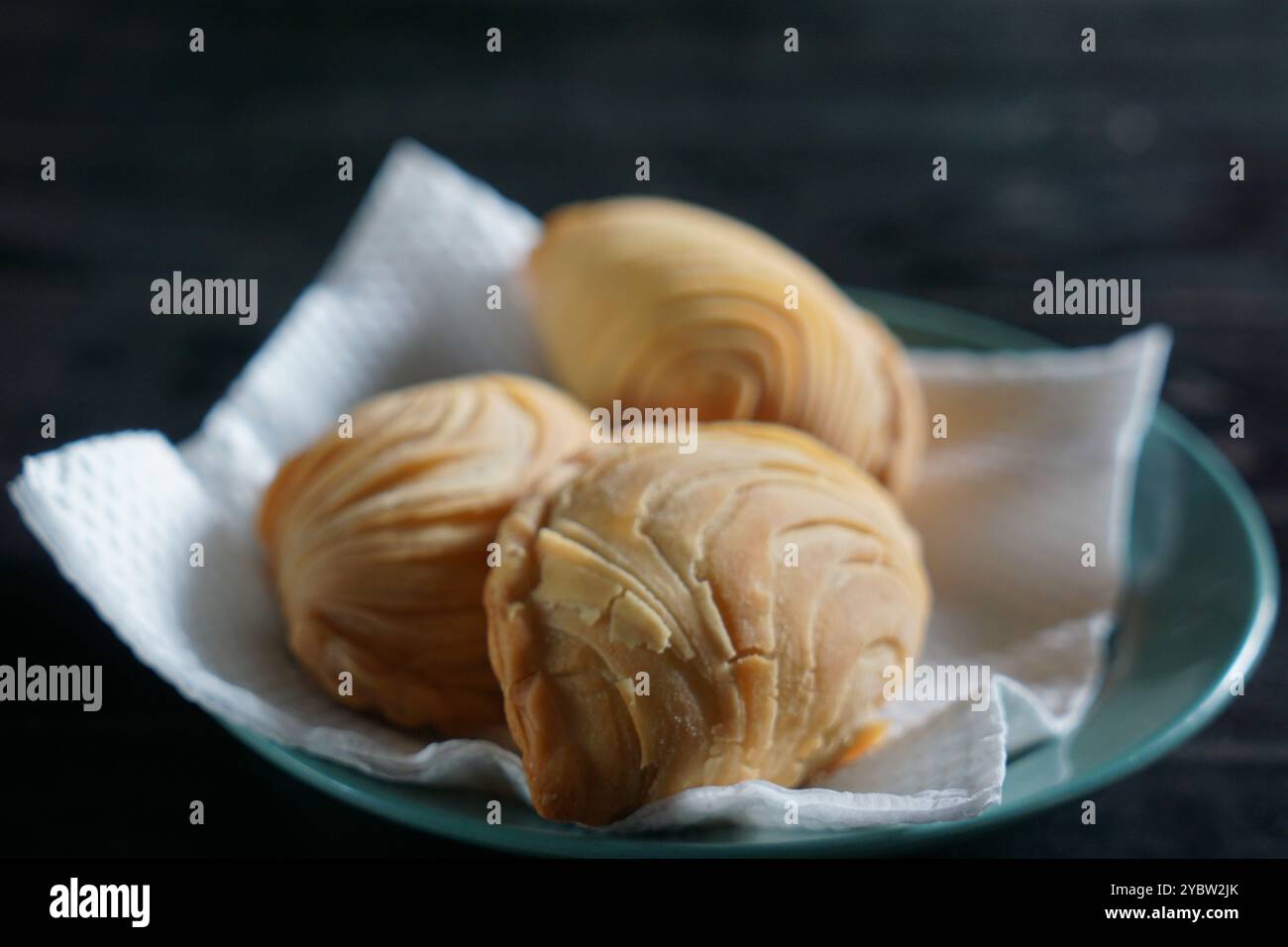 A plate of Malaysian deep fried curry puff or epok-epok isolated on ...