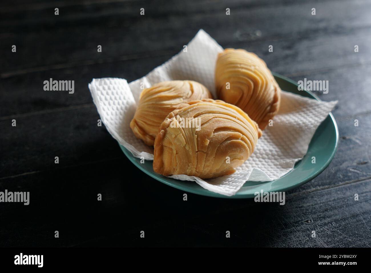 A plate of Malaysian deep fried curry puff or epok-epok isolated on ...