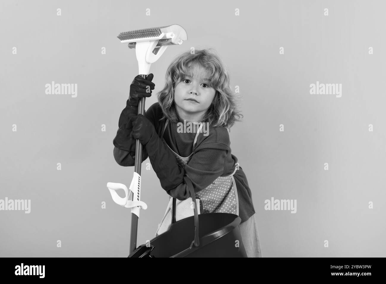 Child cleans at home concept. Kid cleaning with mop to help with ...