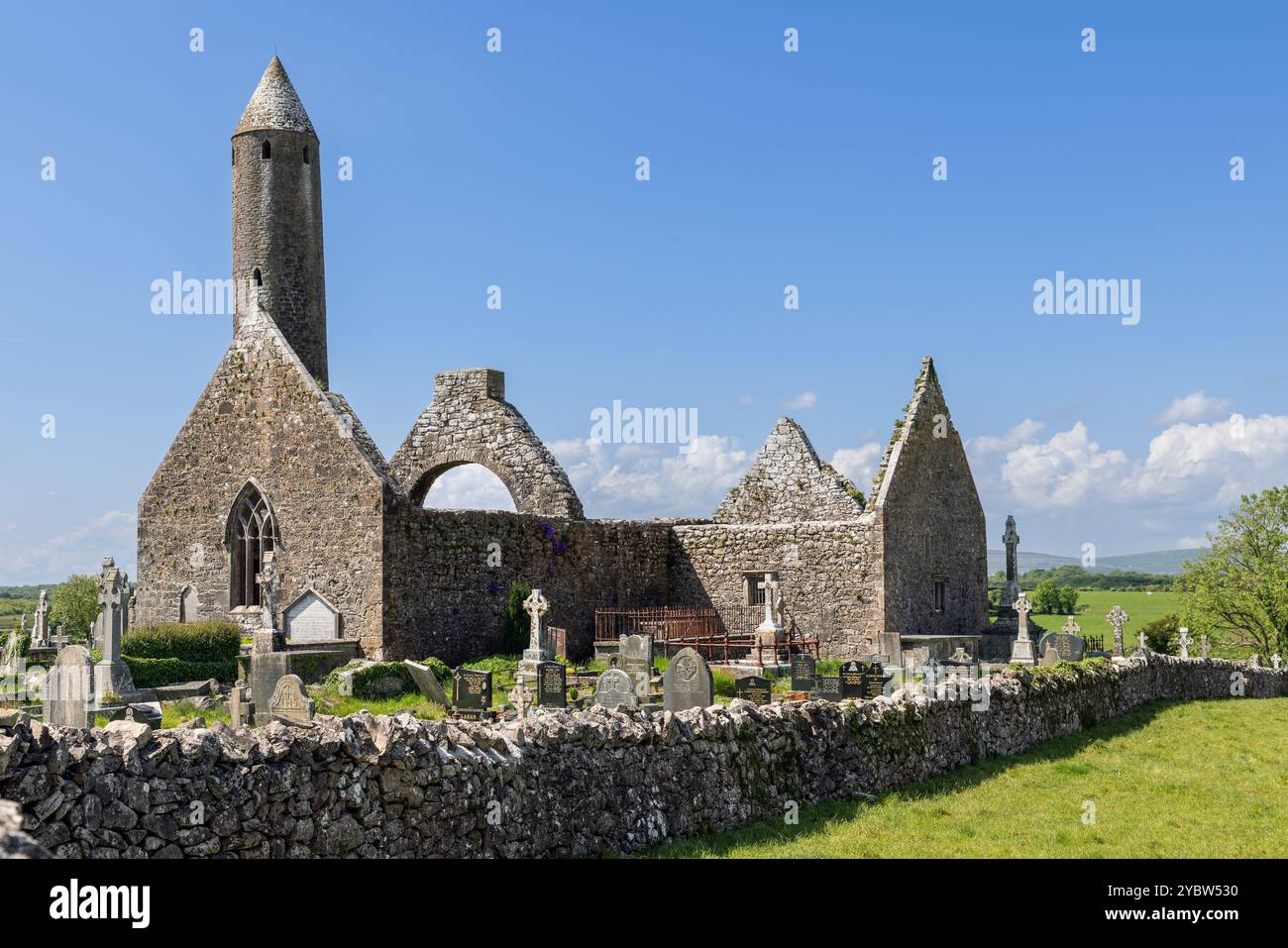 Kilmacduagh Abbey in County Galway, Ireland, features a round tower and ...