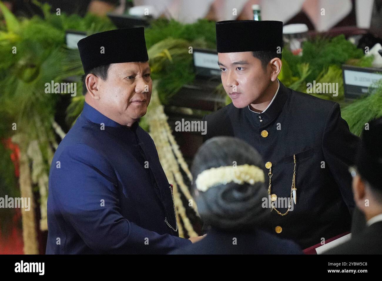 Indonesia's newly-inaugurated President Prabowo Subianto, left, and ...