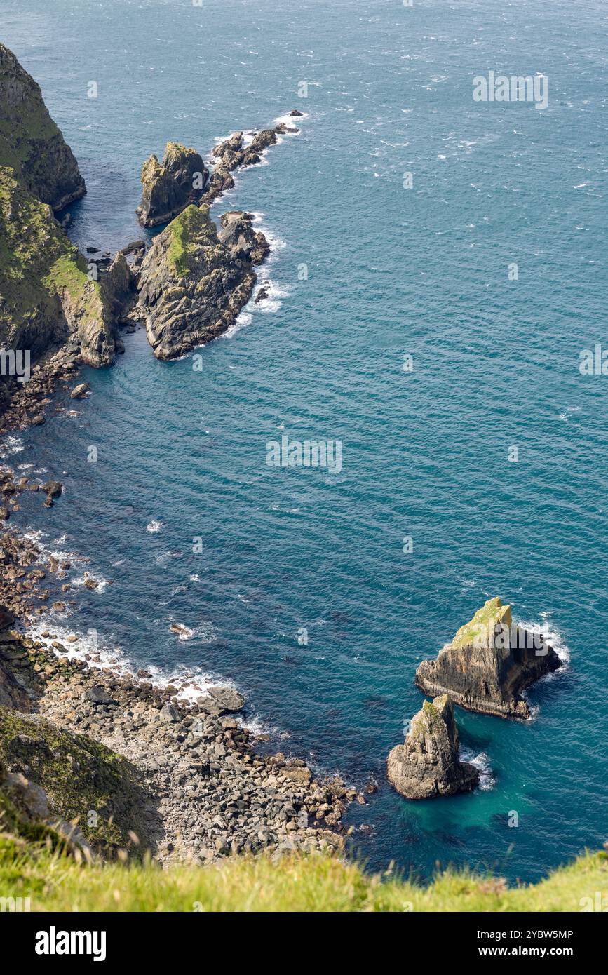 Aerial shot of rugged rocks protruding from the ocean at Slieve League ...