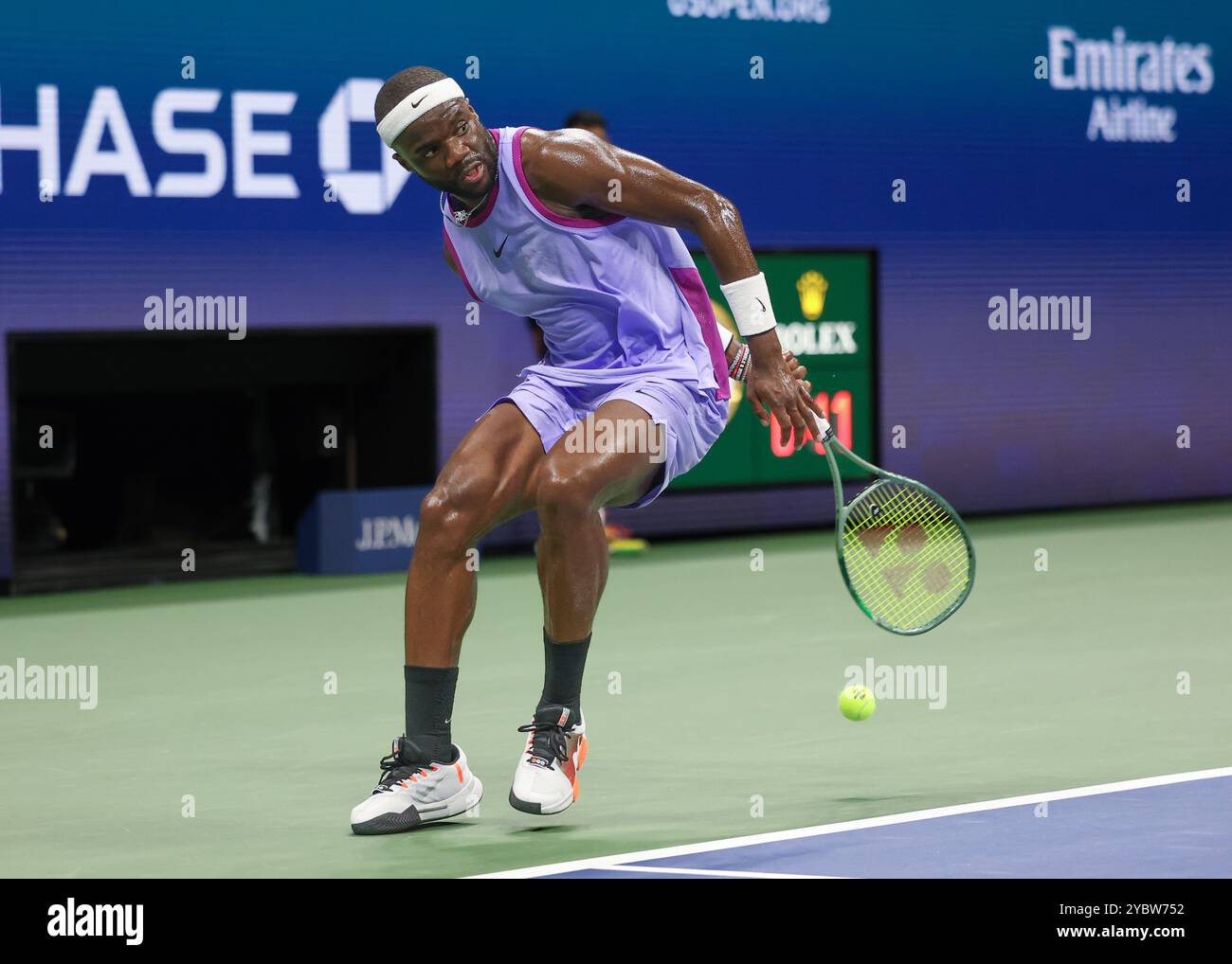 Tennis player Frances Tiafoe playing a trick shot behind his back at ...