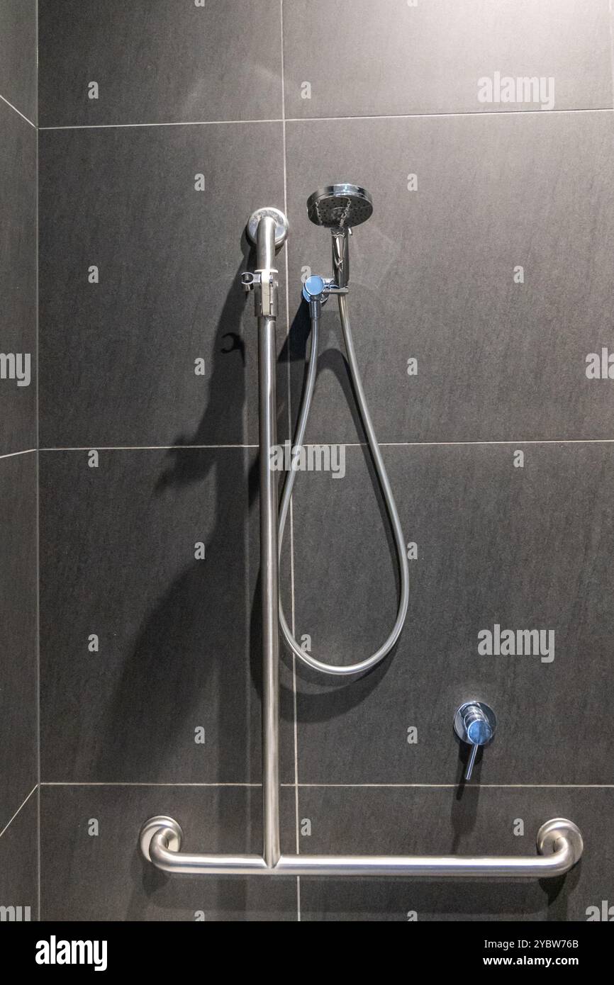 Disability friendly generic restroom with hand rails next to shower ...