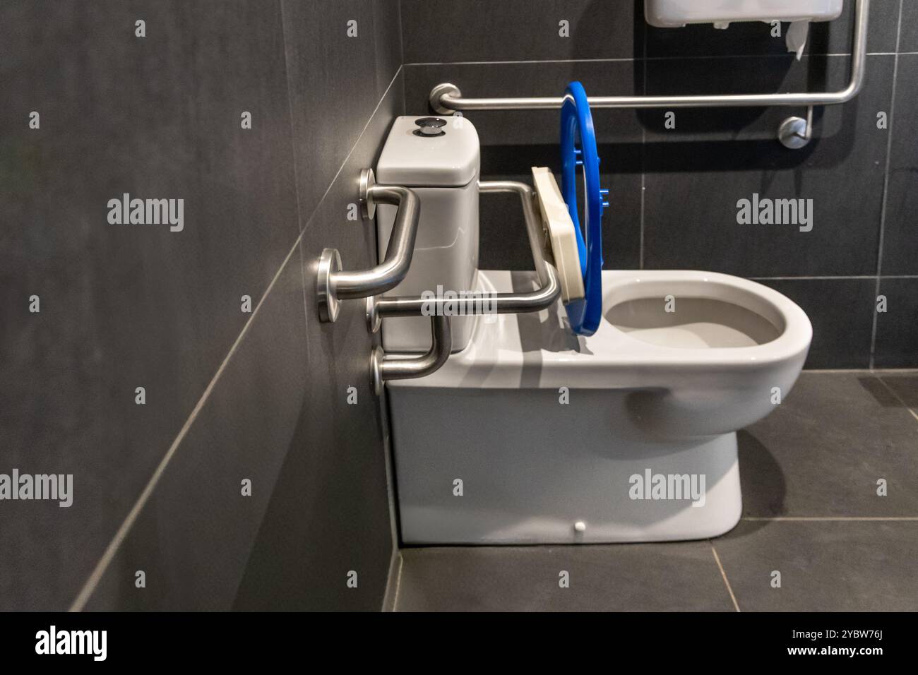 Disability friendly generic restroom toilet bowl with hand rails and ...