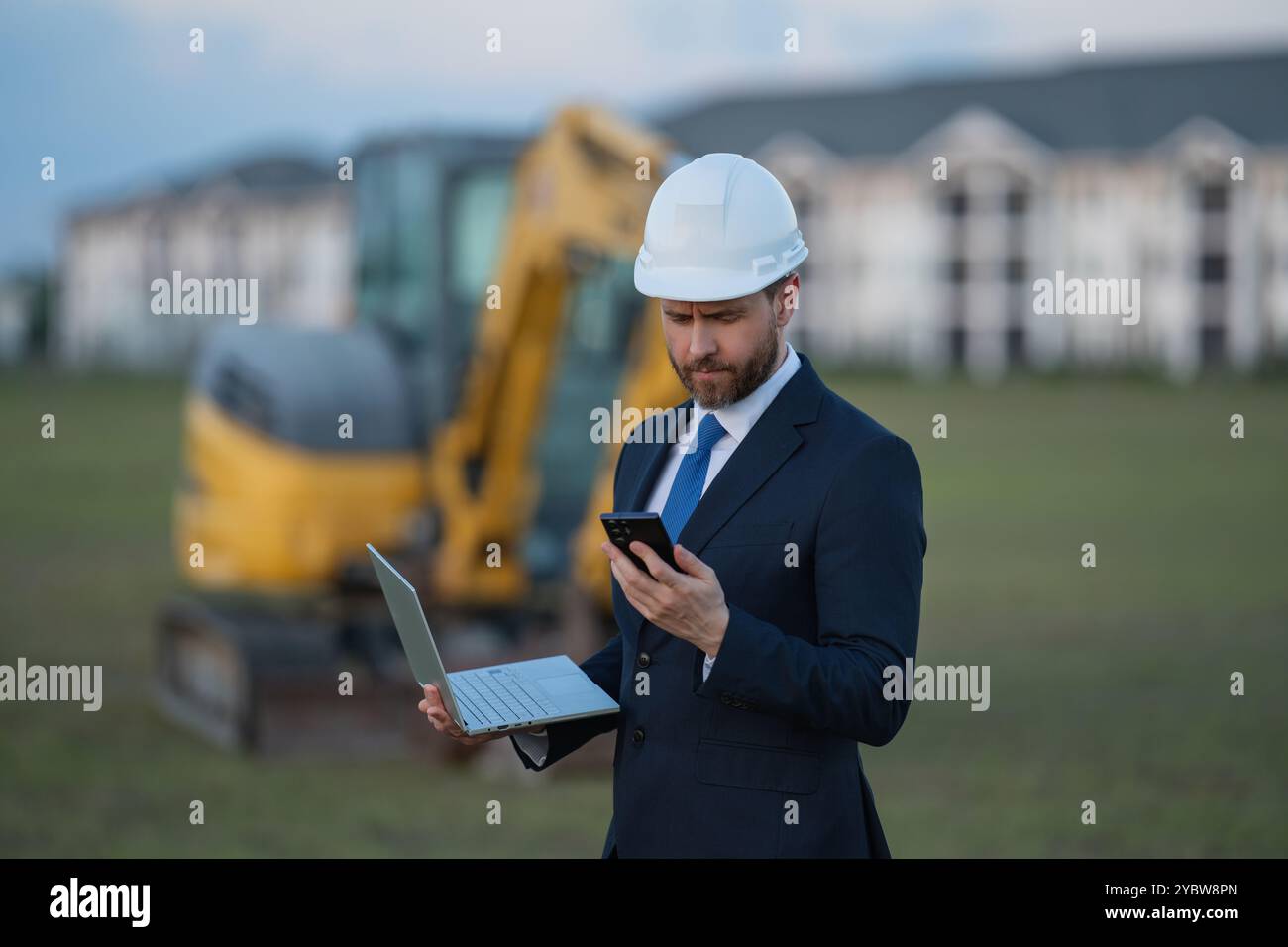 Civil engineer worker at a construction site. Engineer man in front of ...