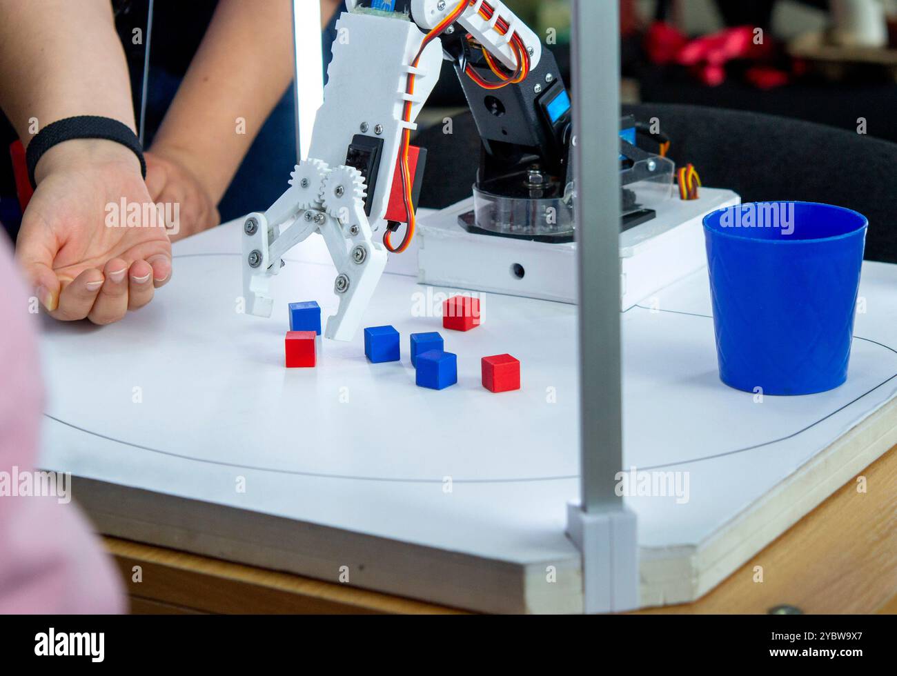 Robot automatic hand taking cubes and putting in glass. Automatic ...