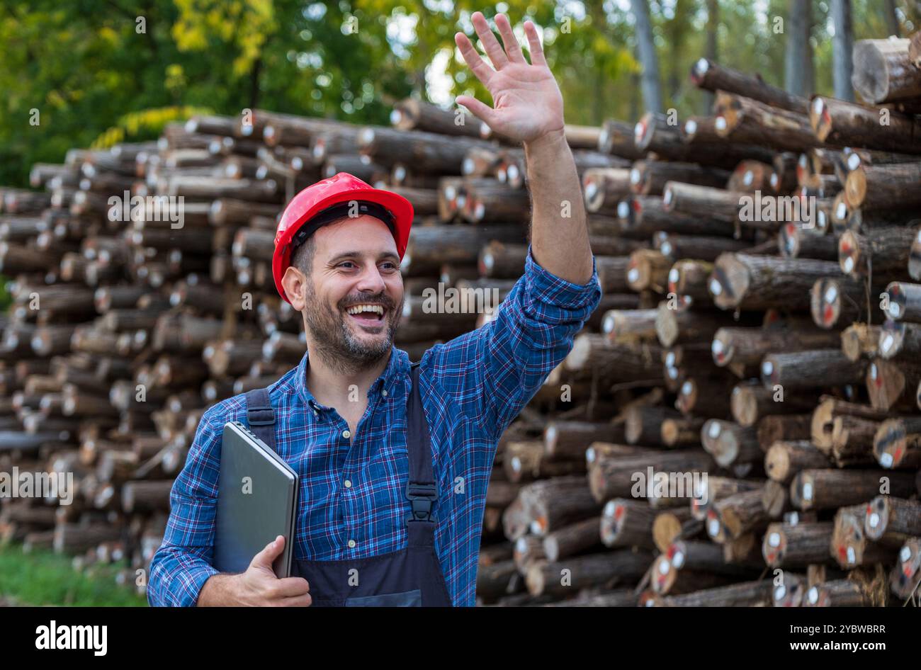 Handsome man forestry engineer waving hand and greeting someone in ...