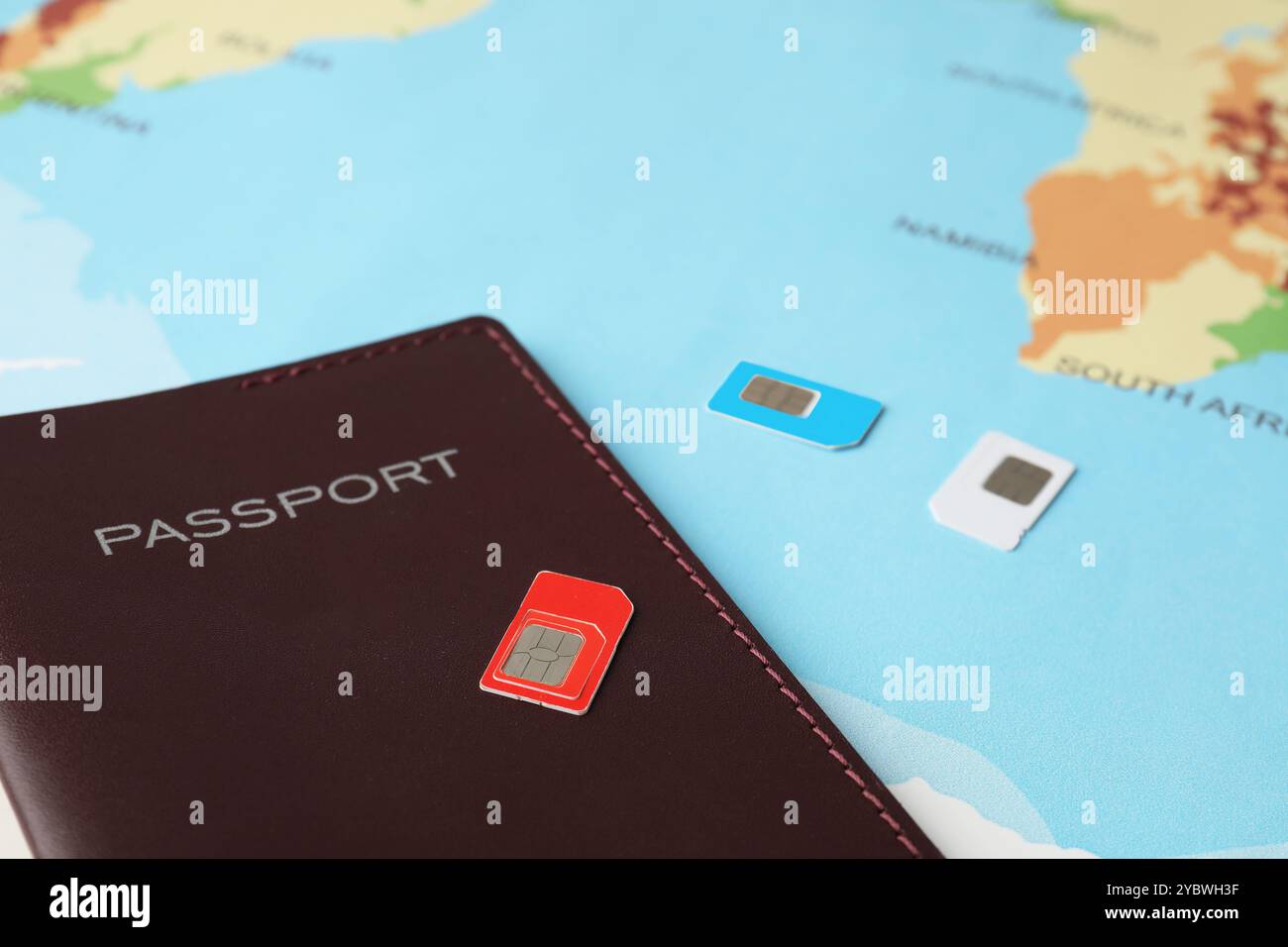 Passport and SIM cards on world map Stock Photo - Alamy