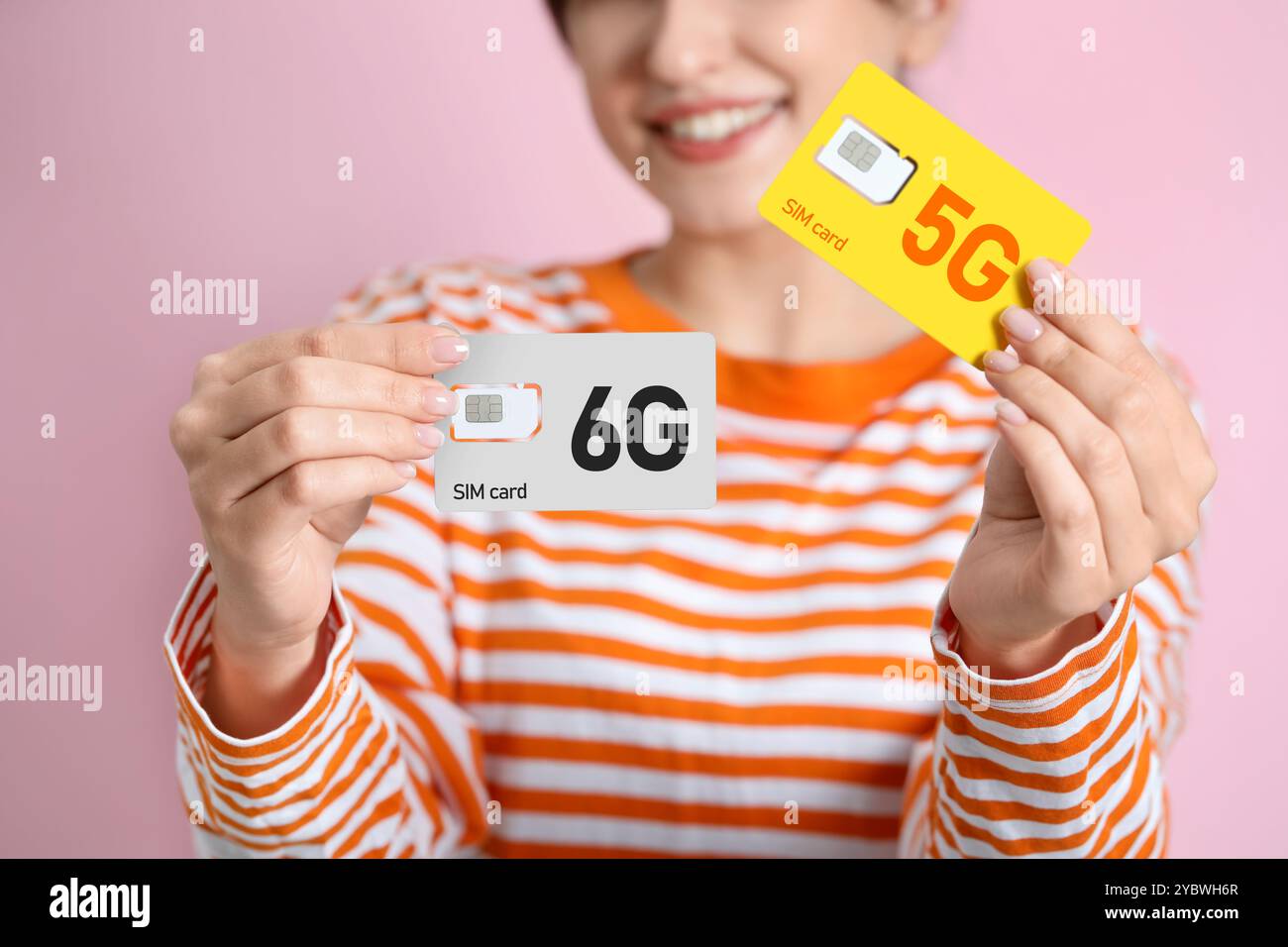 Woman holding 5G and 6G SIM cards on pink background, closeup Stock ...